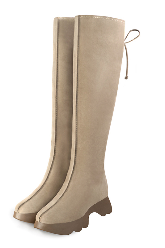 Biscuit beige knee-high boots, with laces at the back. Round toe. Low ...