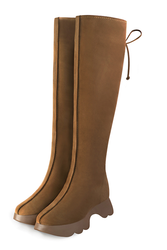 Caramel brown knee-high boots, with laces at the back. Round toe. Low ...