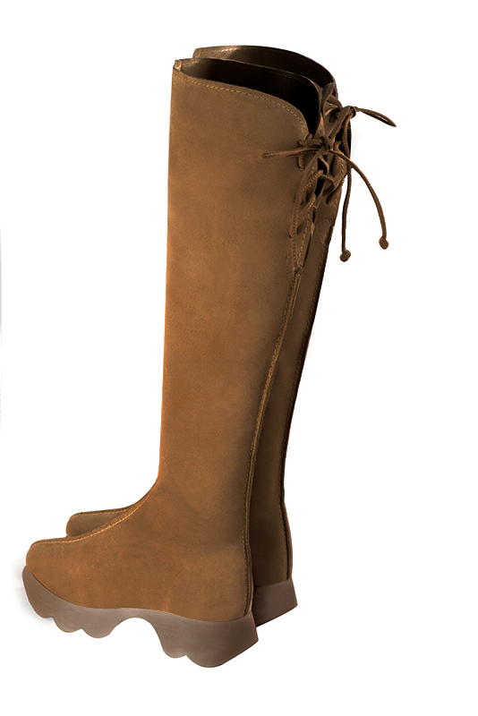 Caramel brown knee-high boots, with laces at the back. Round toe. Low ...